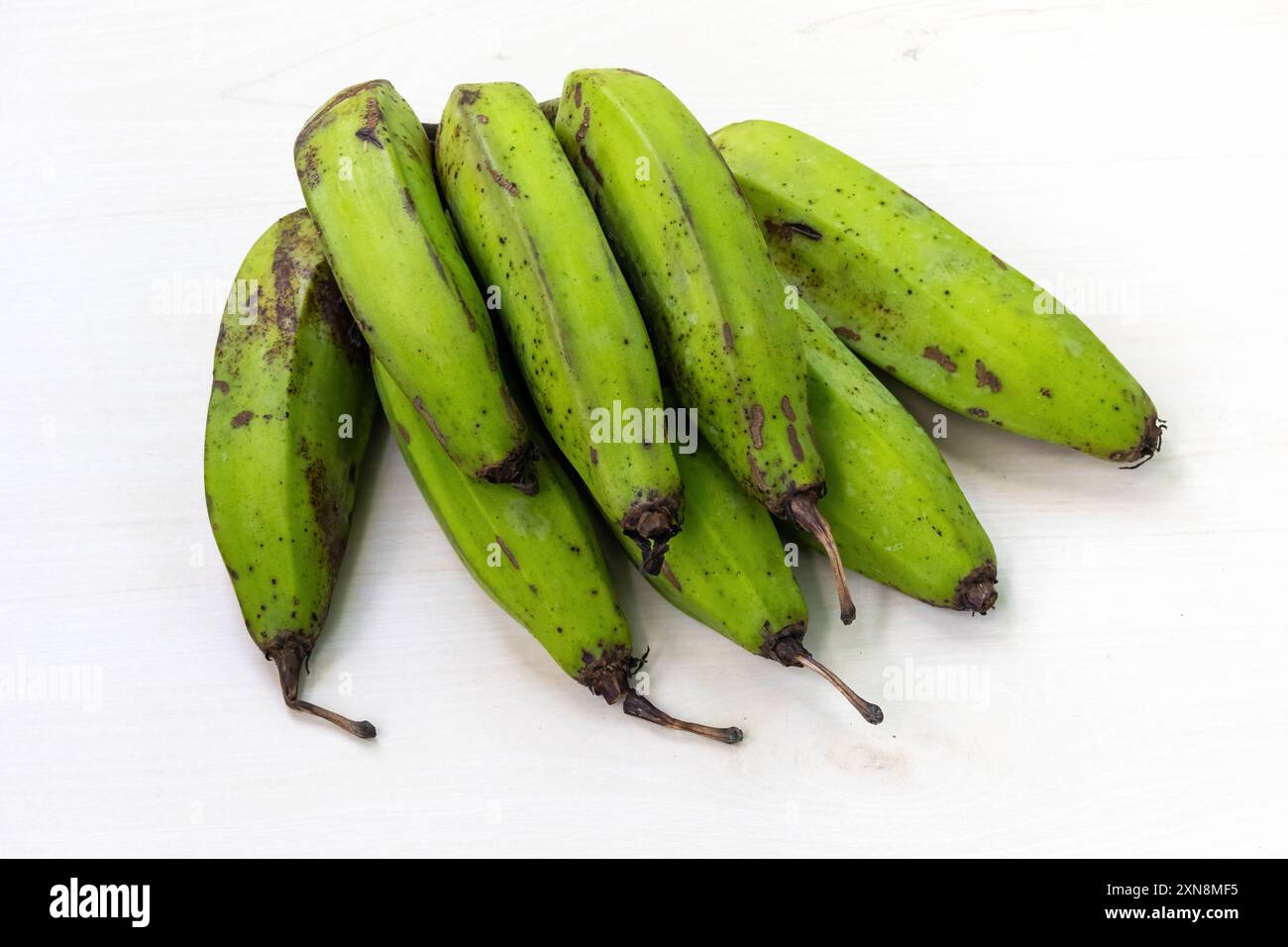 Bunch of fresh green raw bananas on light white wooden background Stock ...