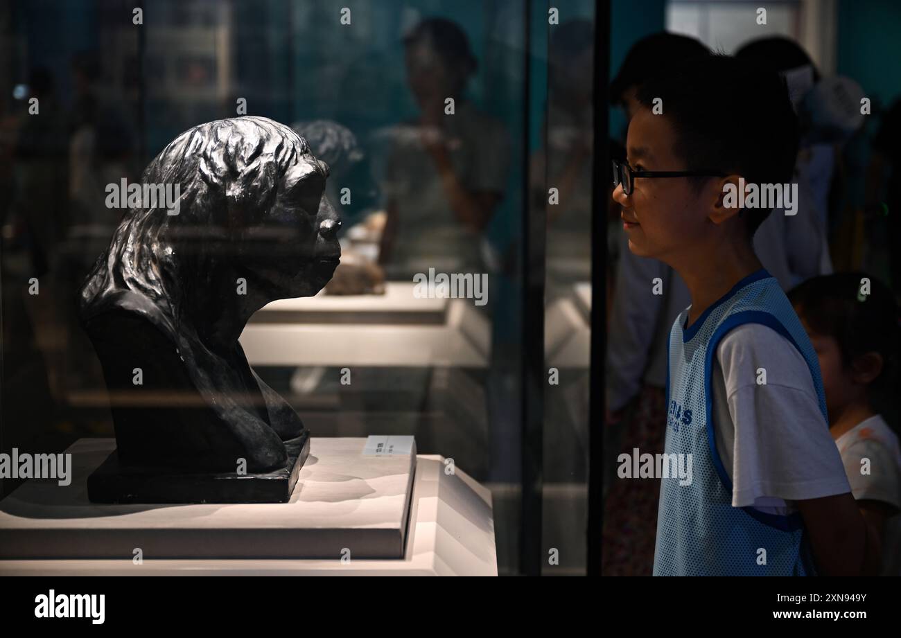Beijing, China's Hainan Province. 30th July, 2024. A child looks at a ...