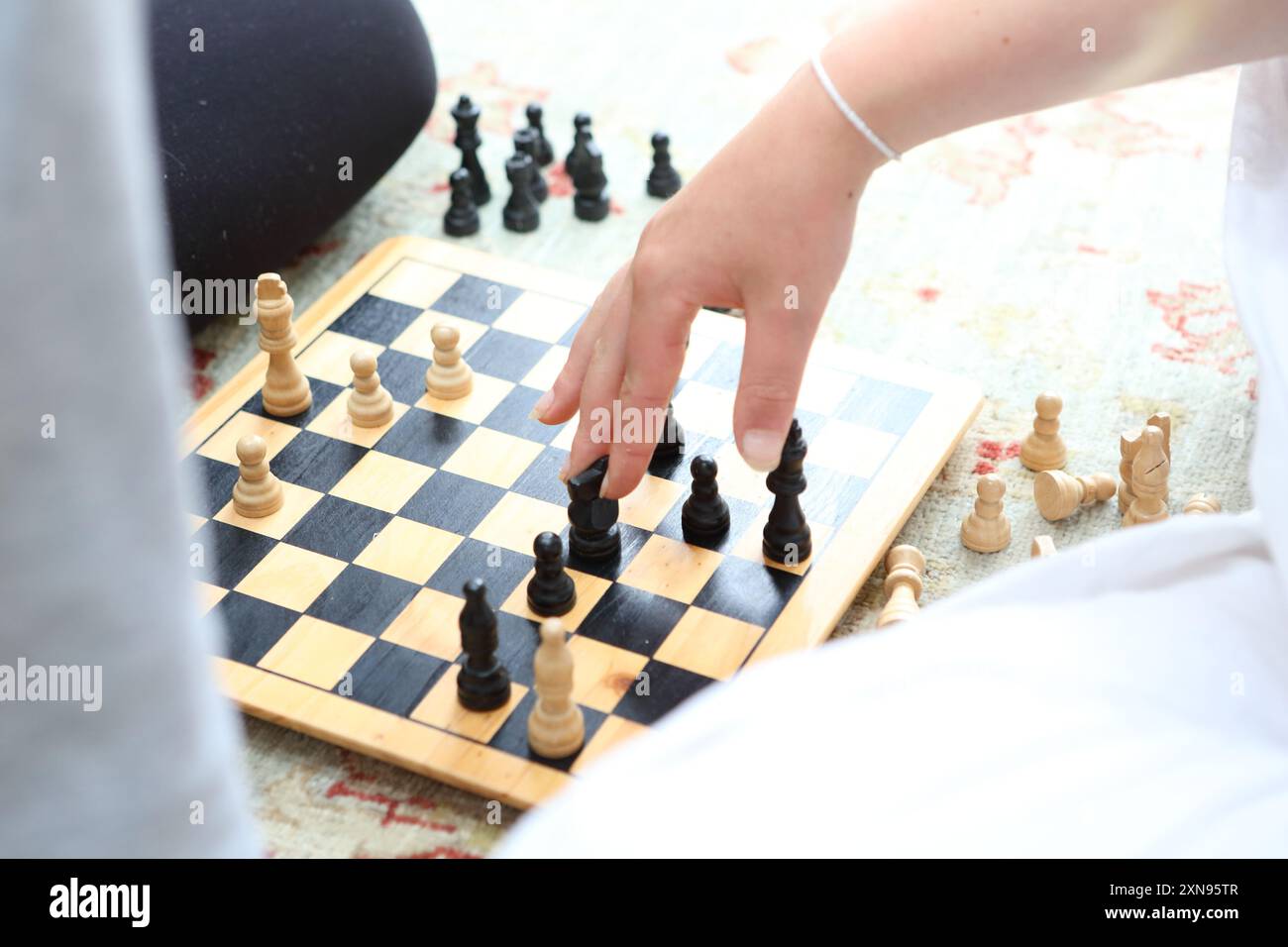 Two girls playing chess sitting on floor - concept thinking skills ...