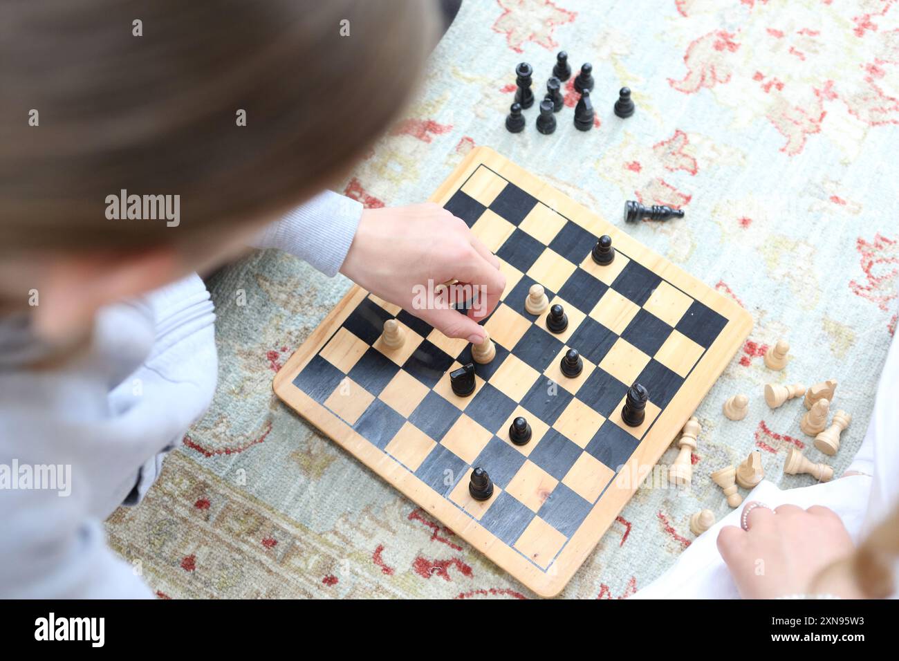 Two girls playing chess sitting on floor - concept thinking skills ...