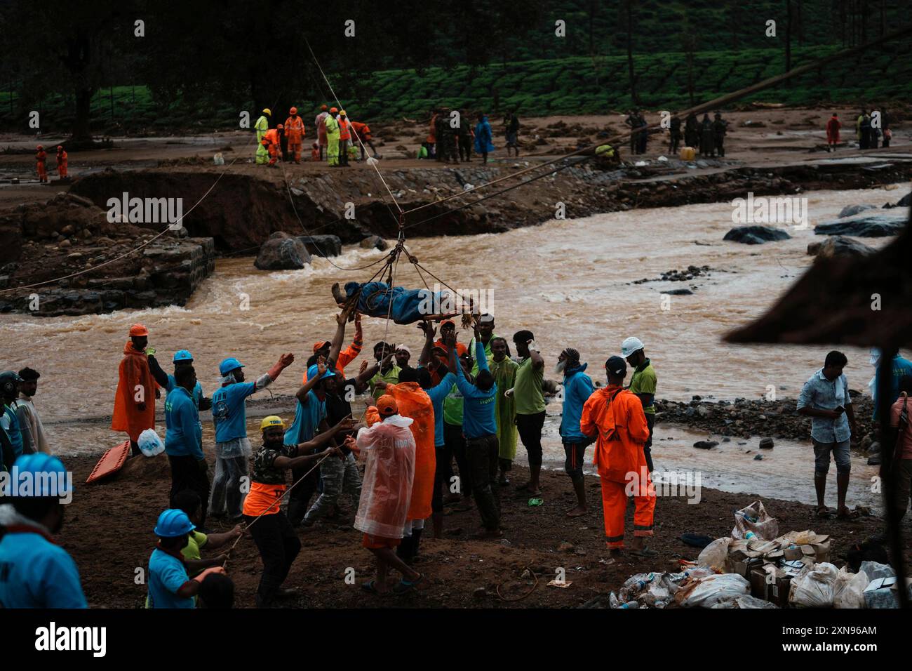Rescuers recover the body of a victim following Tuesday’s landslides at ...