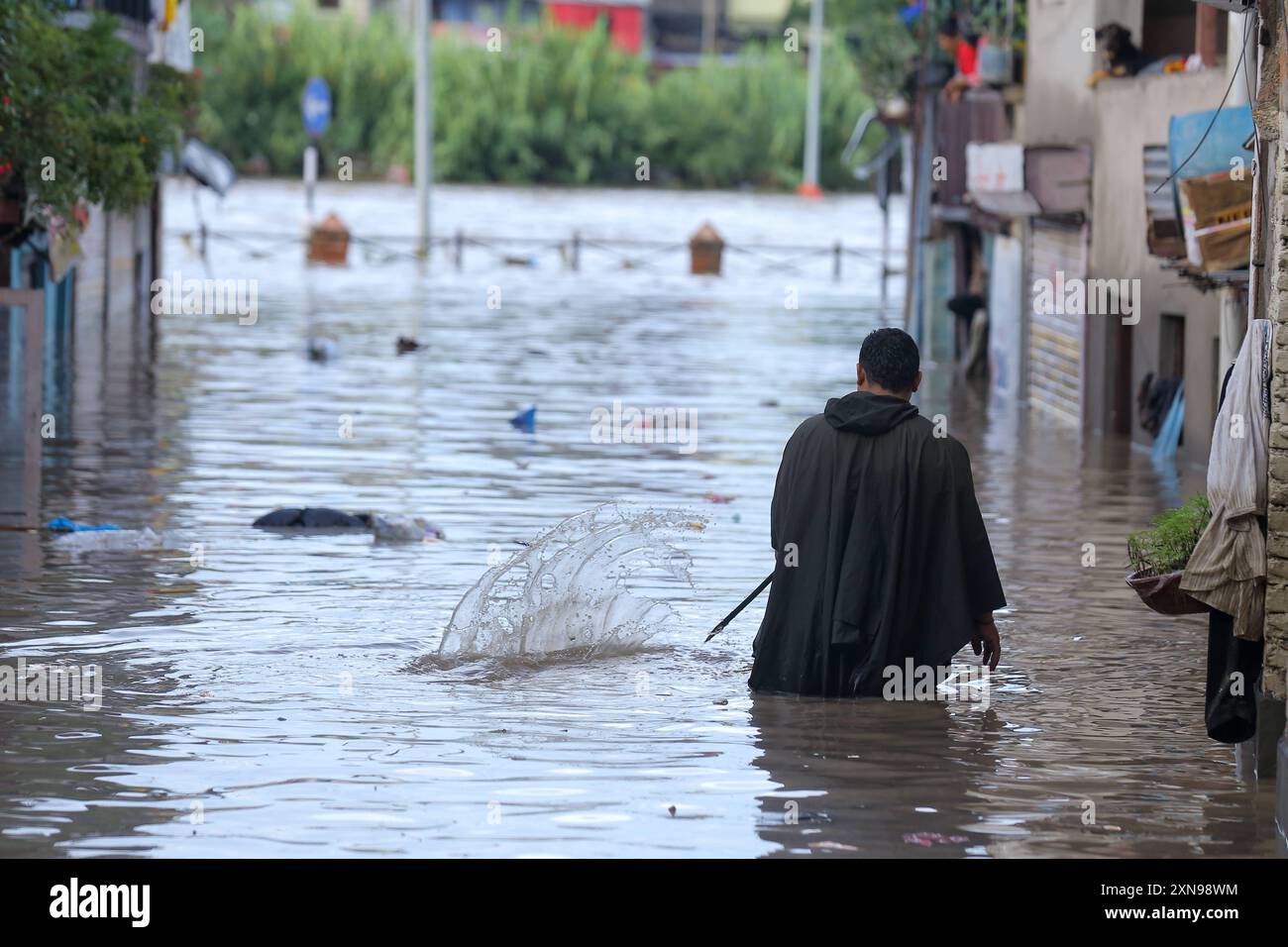 Heavy rain flood houses in Nepal A Nepali man is wading through the ...