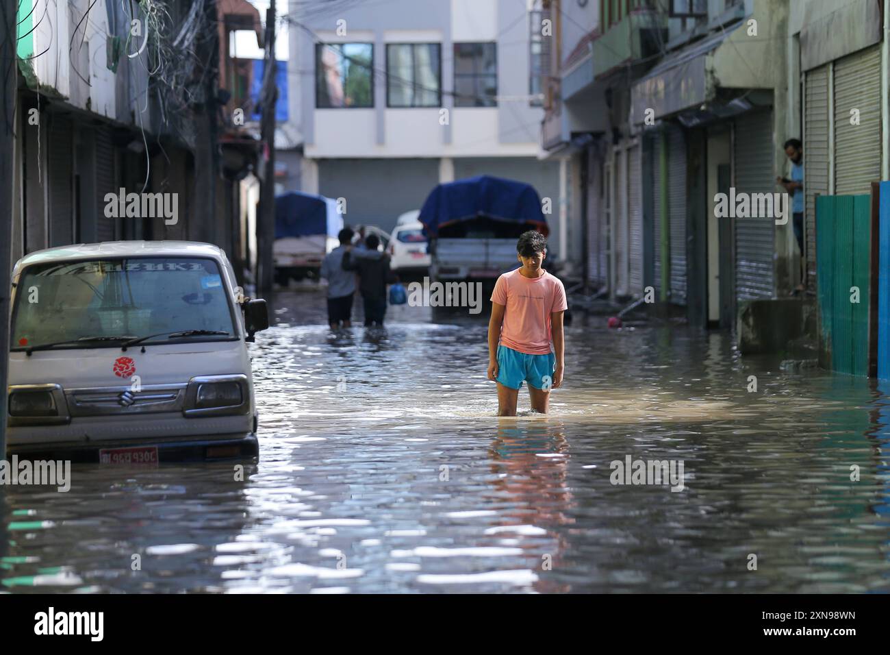 Heavy rain flood houses in Nepal A Nepali man is wading through the ...