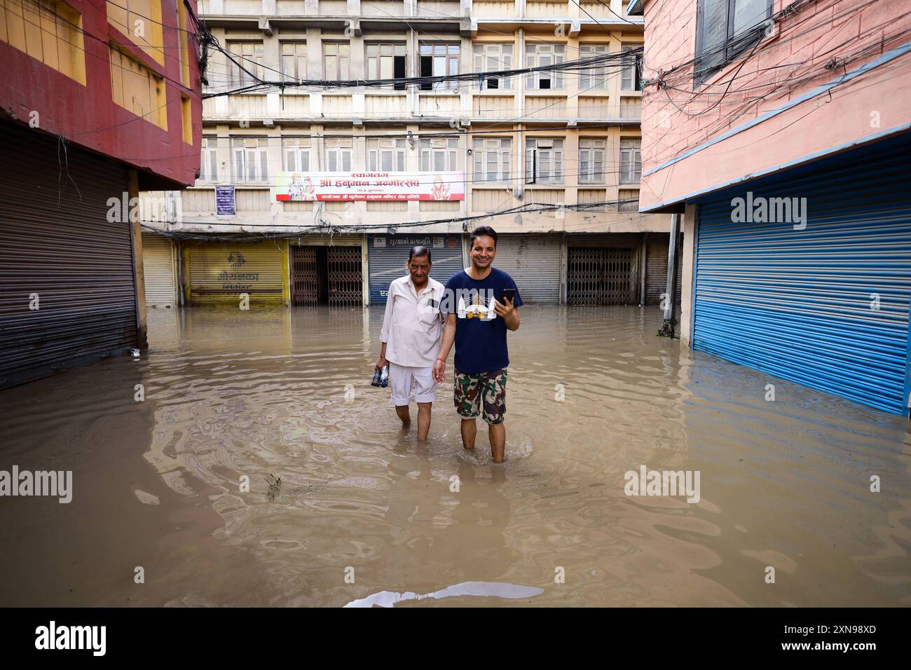 Heavy rain flood houses in Nepal A Nepali man is wading through the ...