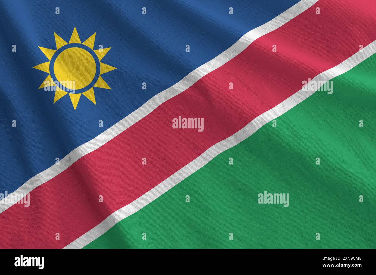 Namibia flag depicted on folded wavy fabric of old cloth close up Stock ...