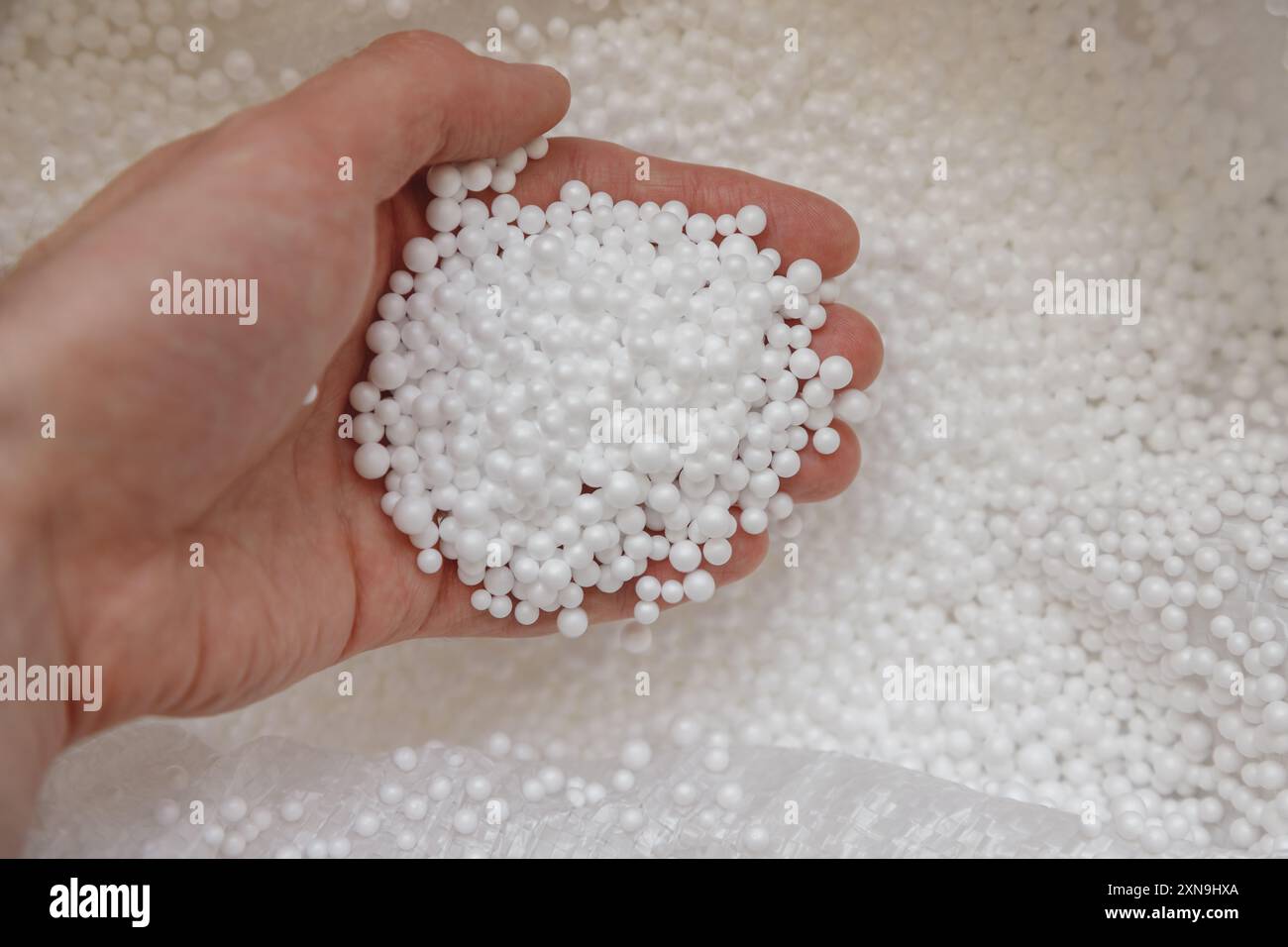 Polystyrene balls in hand. Packaging of fragile goods, filling for ...