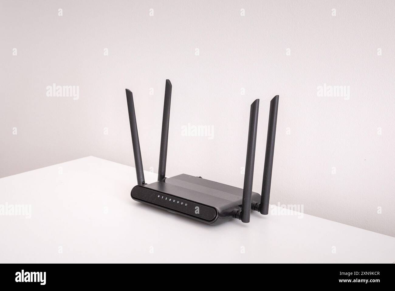 black wifi router on white table indoors. wireless connection concept ...