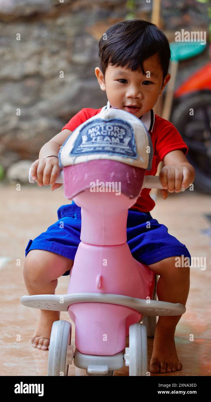 baby boy riding dino toy, cute behavior of children exploring ...