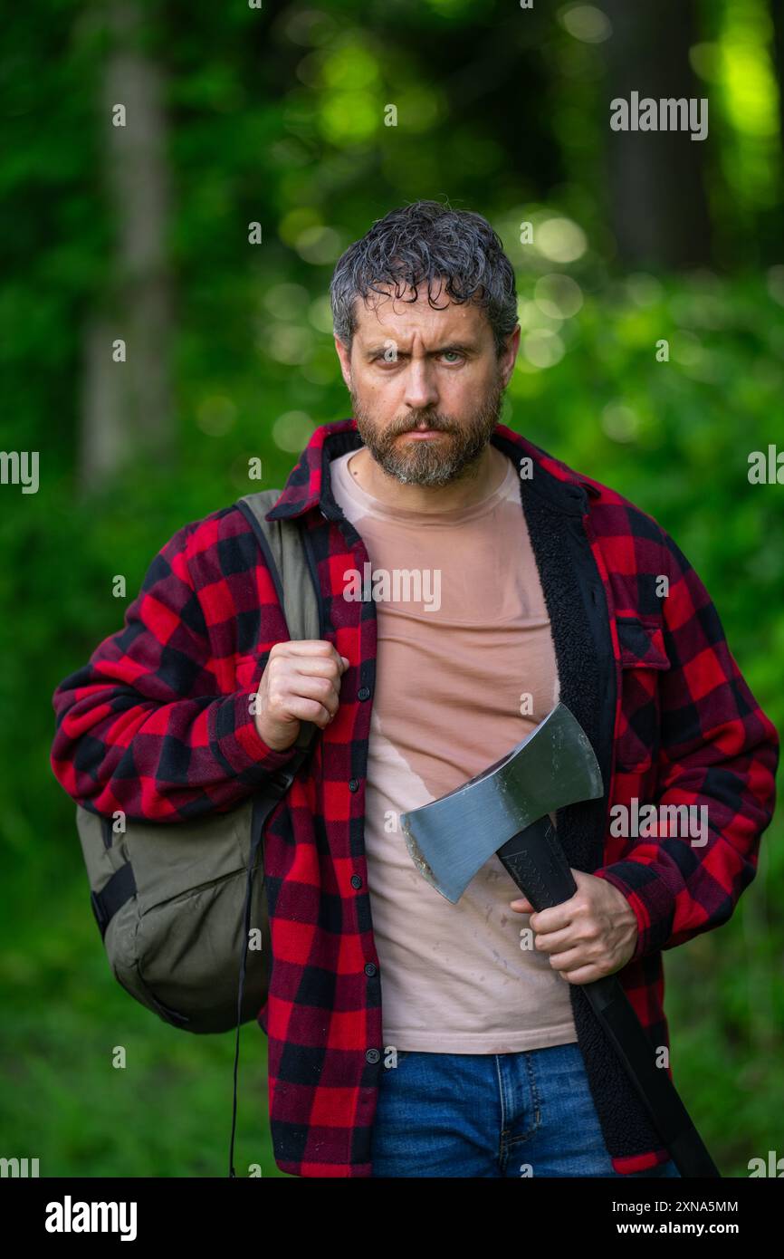 Lumberjack in forest. Photo of the lumberjack in the woods. Strong ...