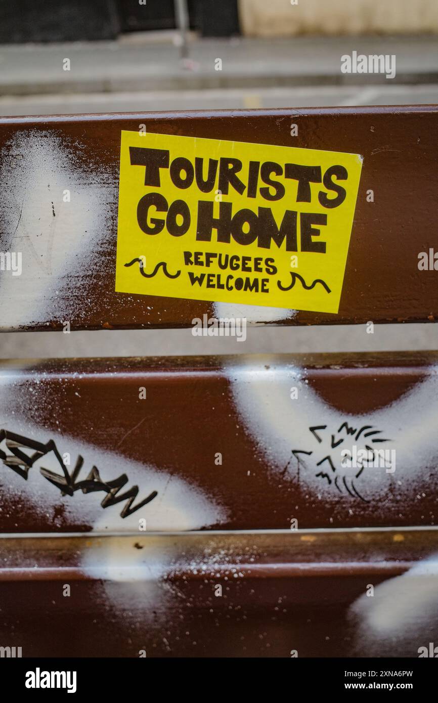 Barcelona, Spain - 28 July, 2024: Tourist go home sticker on a park ...