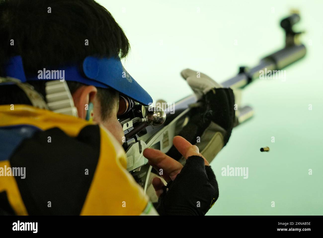 An empty cartridge shell ejects from the rifle of Japan's Naoya Okada ...