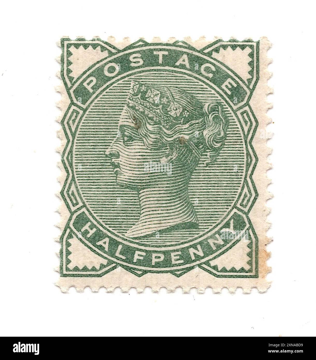 A vintage Queen Victoria halfpenny green postage stamp from Great Britain on a white background ...