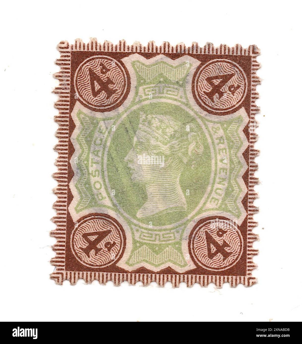 A vintage Queen Victoria 4d postage stamp from Great Britain on a white ...