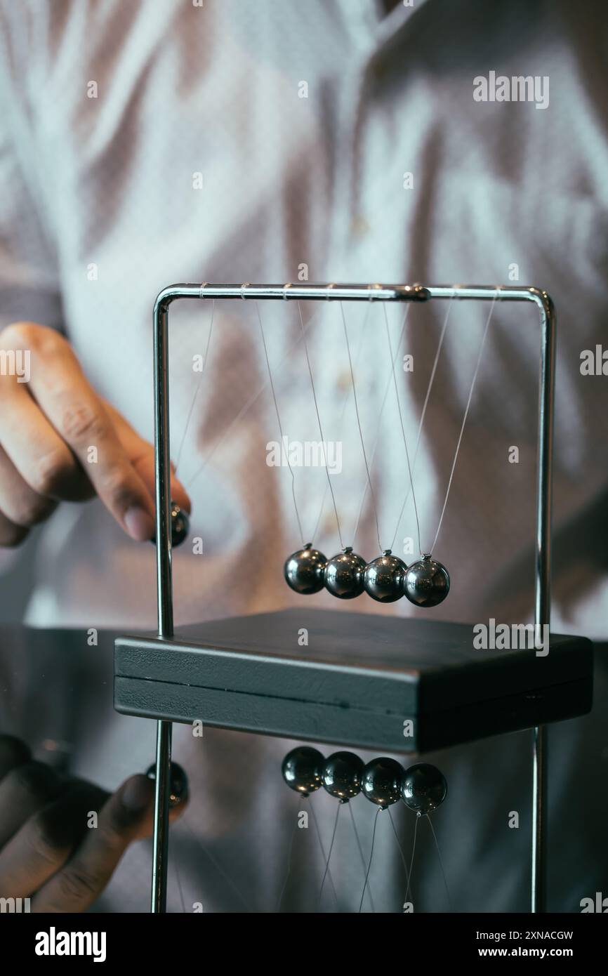 Blurred man pulling ball newton hi-res stock photography and images - Alamy