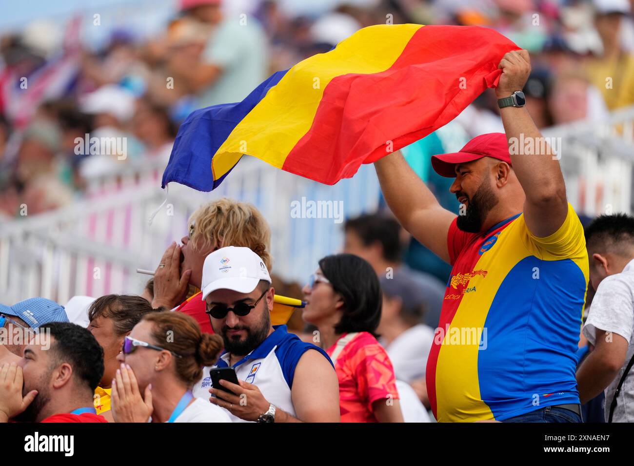 A fan of Romania cheers during the men's pair rowing semifinal at the ...