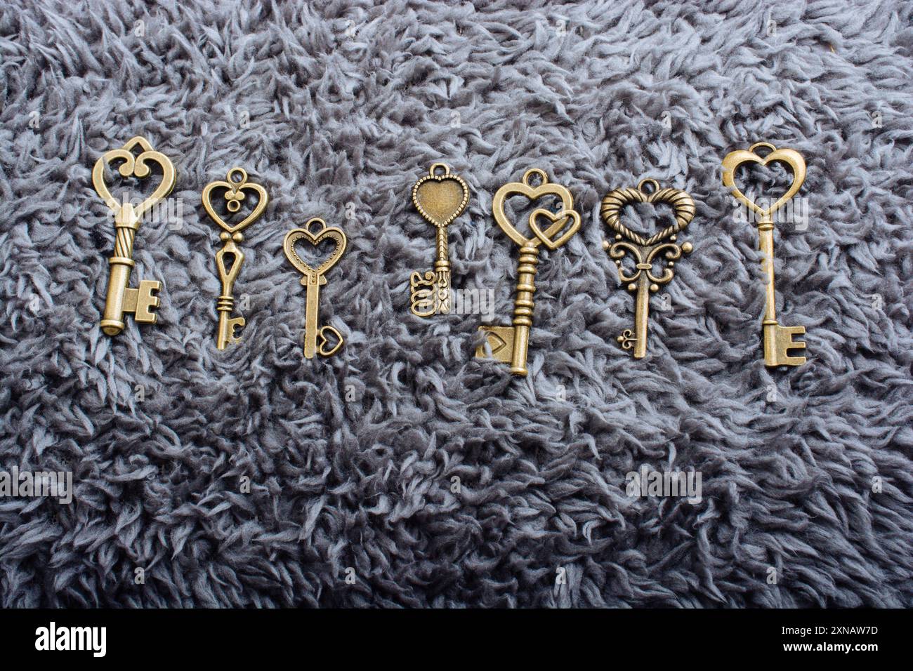 Set of small decorative keys on fabric Stock Photo - Alamy