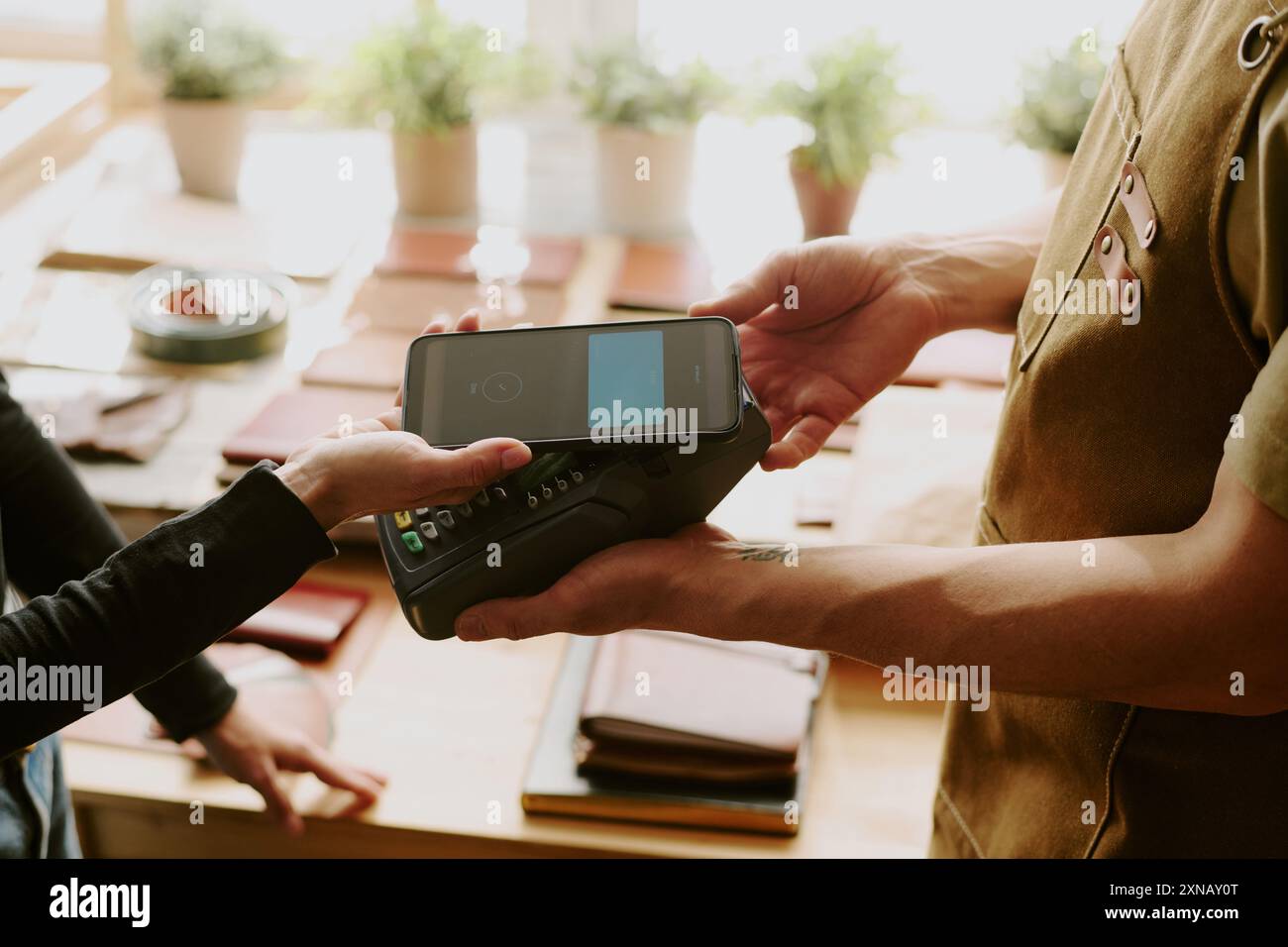 Customer hand tapping terminal holding hi-res stock photography and ...