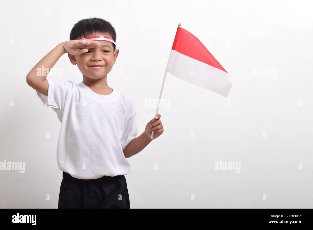 Cute little Asian boy giving salute celebrate Indonesian independence ...