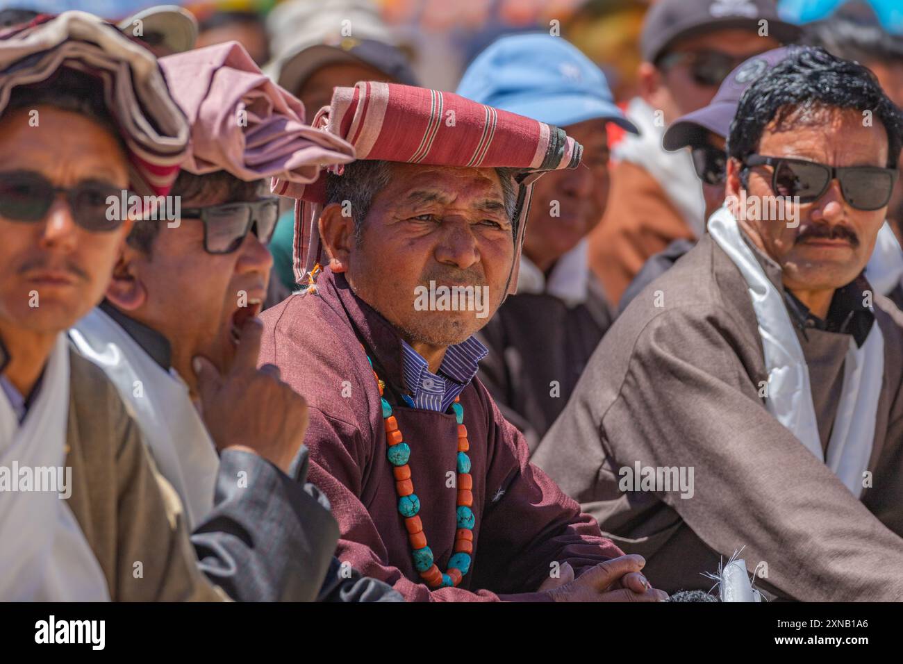 A group of Ladakhi Men and women folk siting together in the open at ...