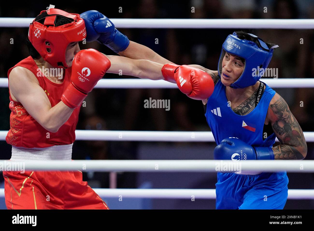 Philippines' Hergie Bacyadan, right, hits China's Li Qian in their ...