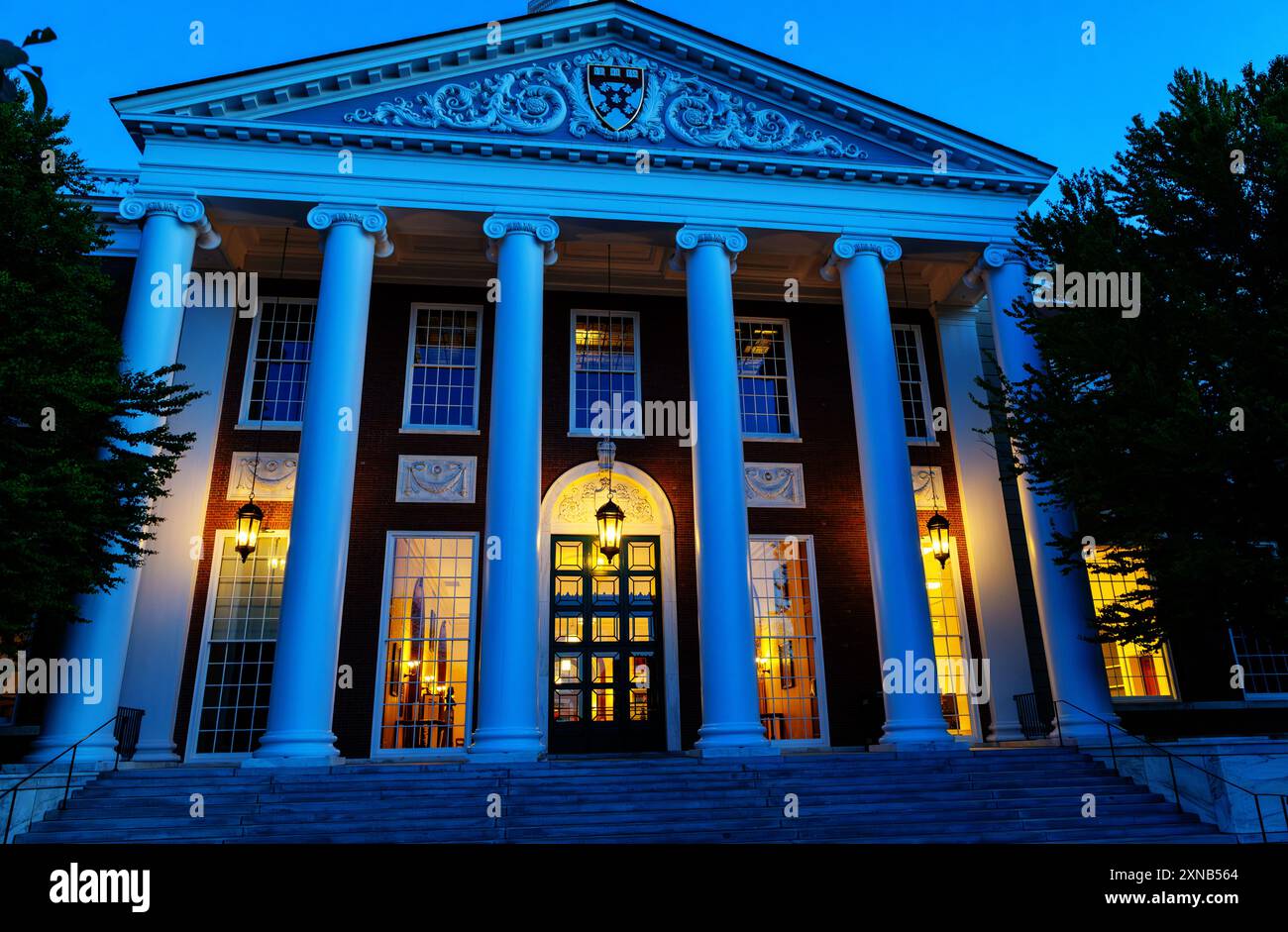 Boston, Massachusetts, USA - May 9, 2024: The Baker Library at nightfall on the Harvard Business ...