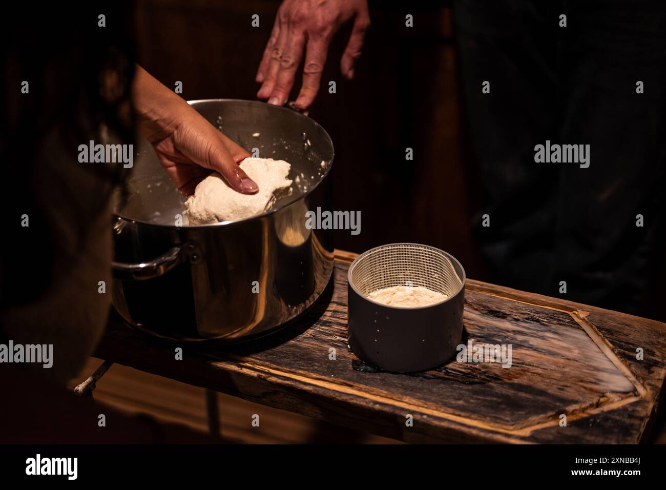 close-up view of hands crafting cheese using traditional and manual ...
