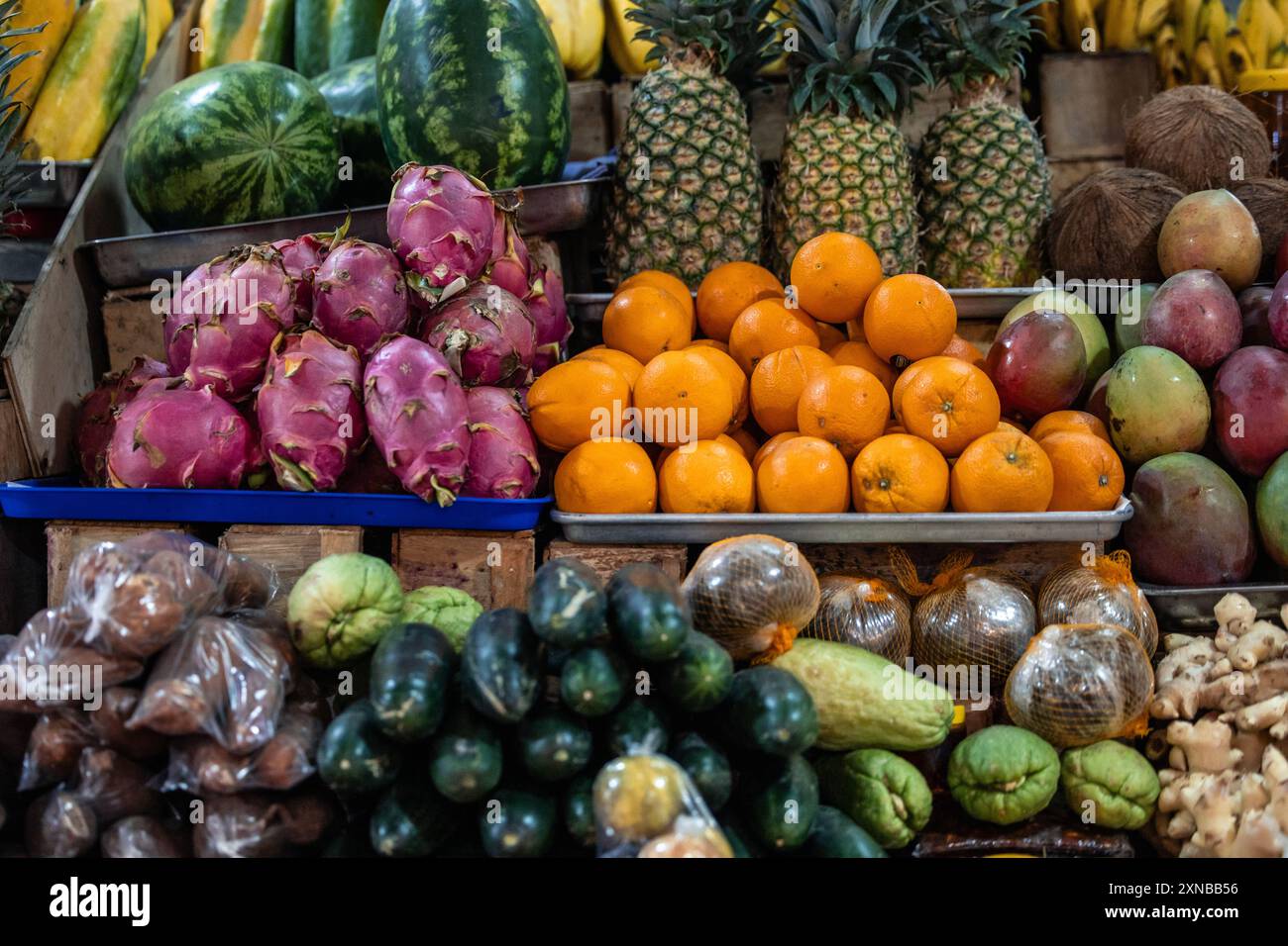tropical fruits displayed in traditional market. The selection includes ...