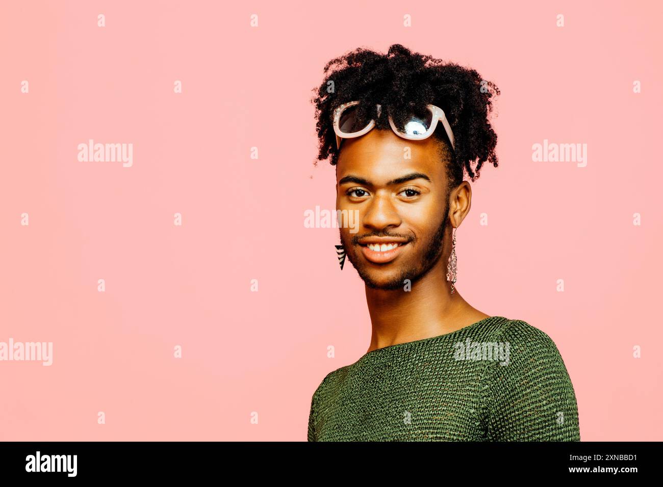 Colorful studio portrait of a young man smiling Stock Photo - Alamy