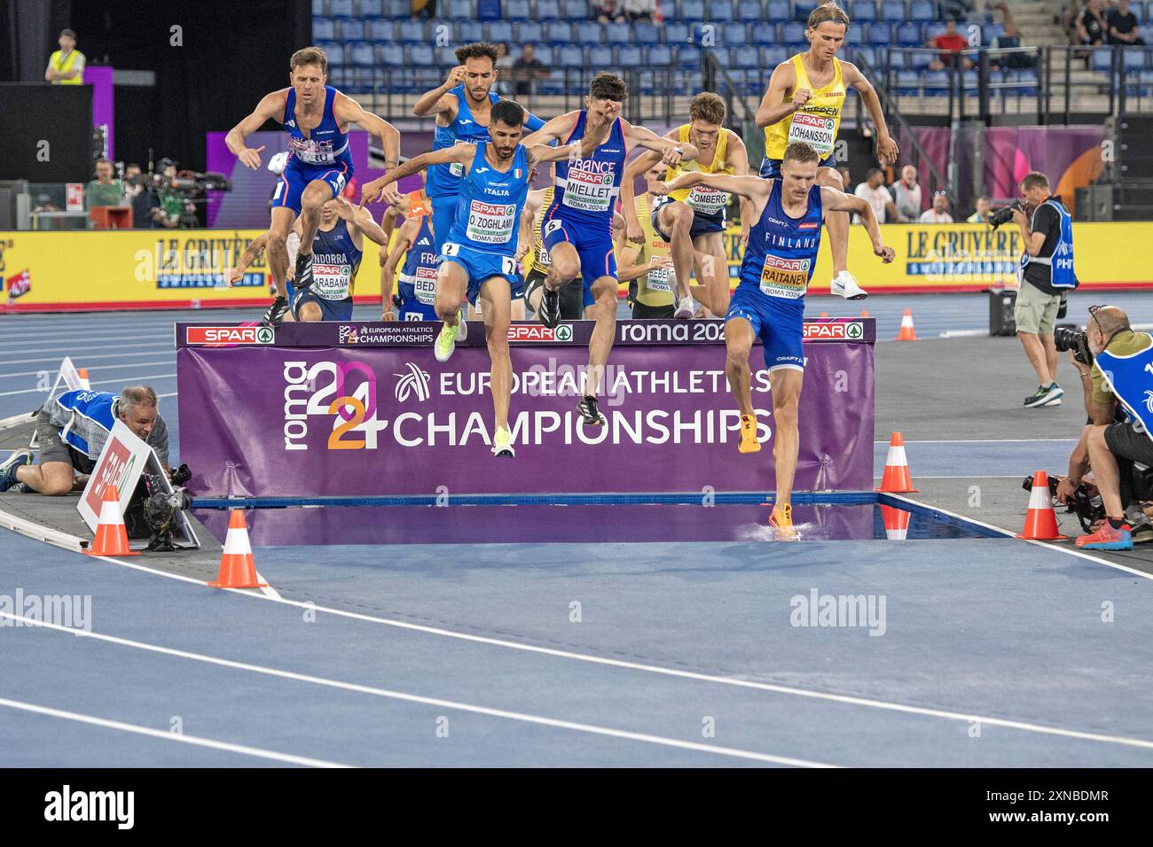 Crossing the barrier with water during the men's 3000m steeplechase ...