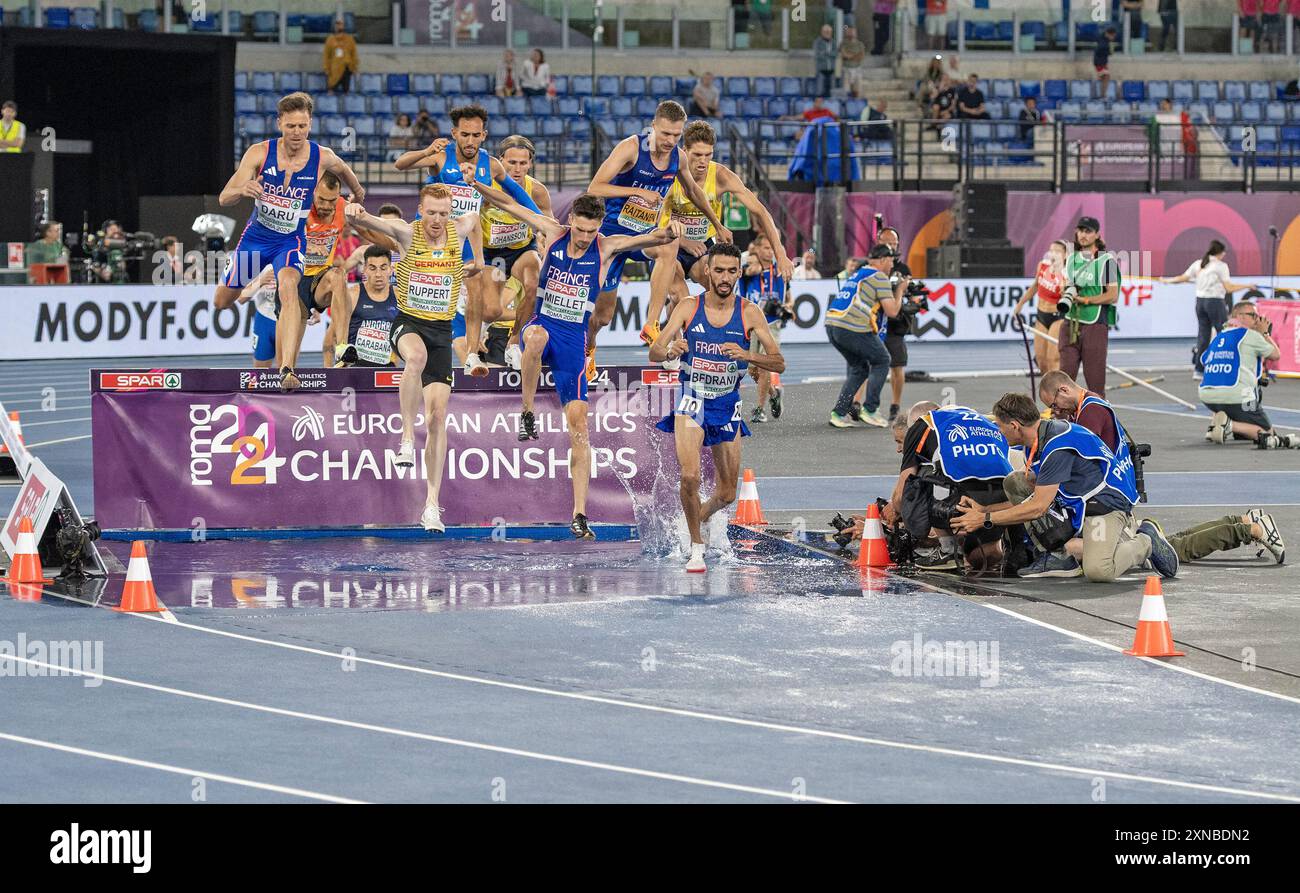 Crossing the barrier with water during the men's 3000m steeplechase ...