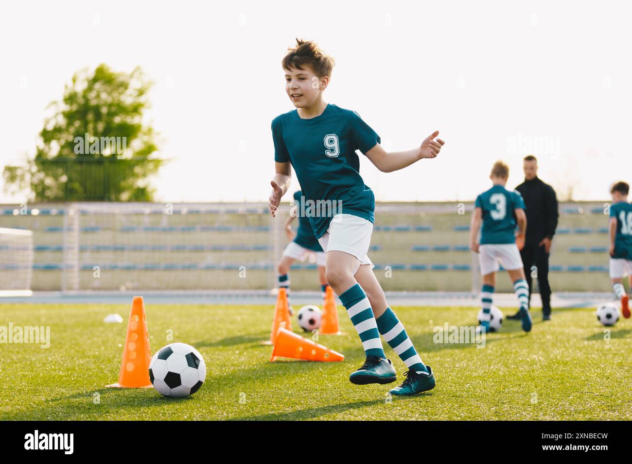 School boys attending soccer football training on grass pitch. Young ...