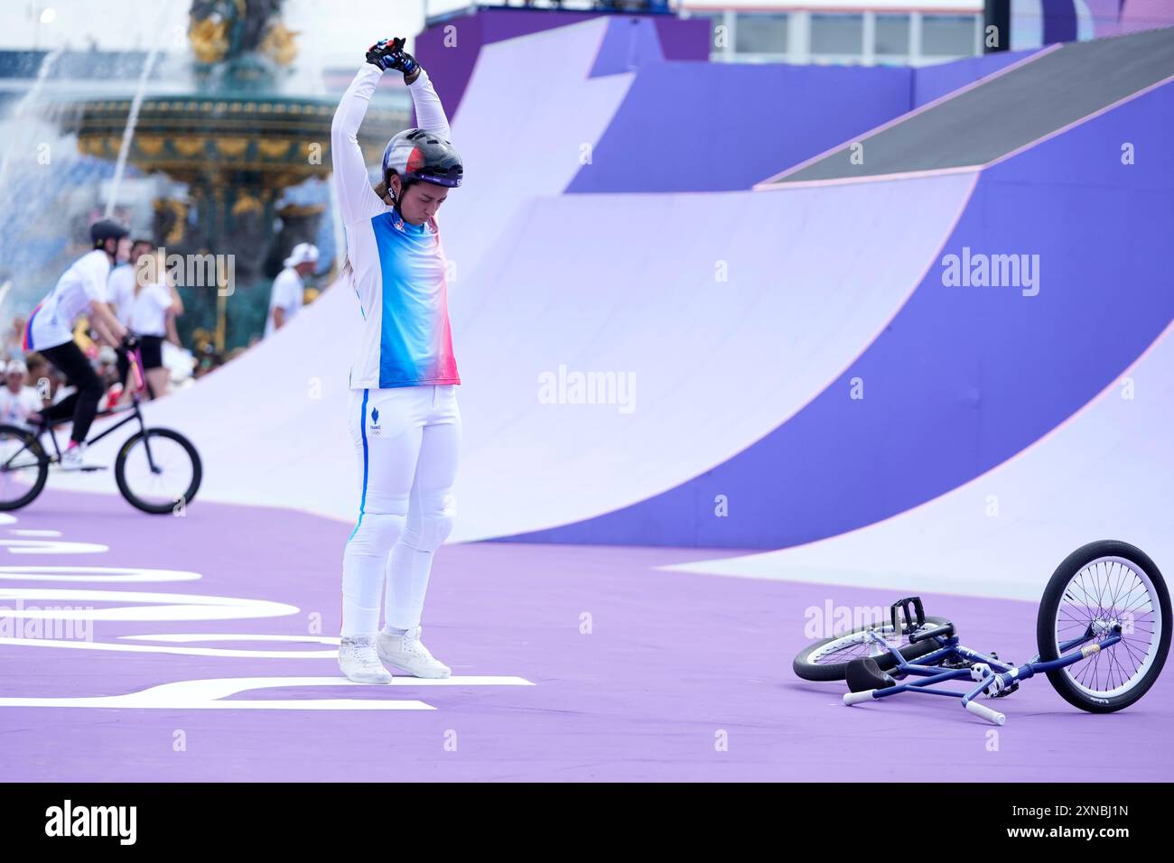 Laury Perez, of France, stretches after crashing during the warmup ...