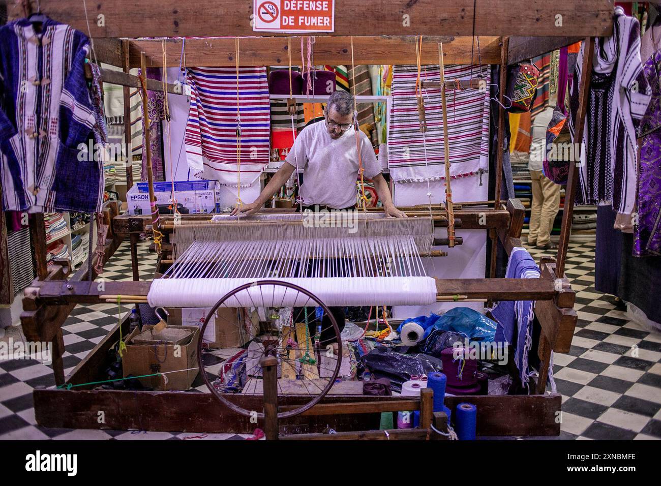 Tanger, Morocco. 25th July, 2024. A man works on a hand-made loom in a ...