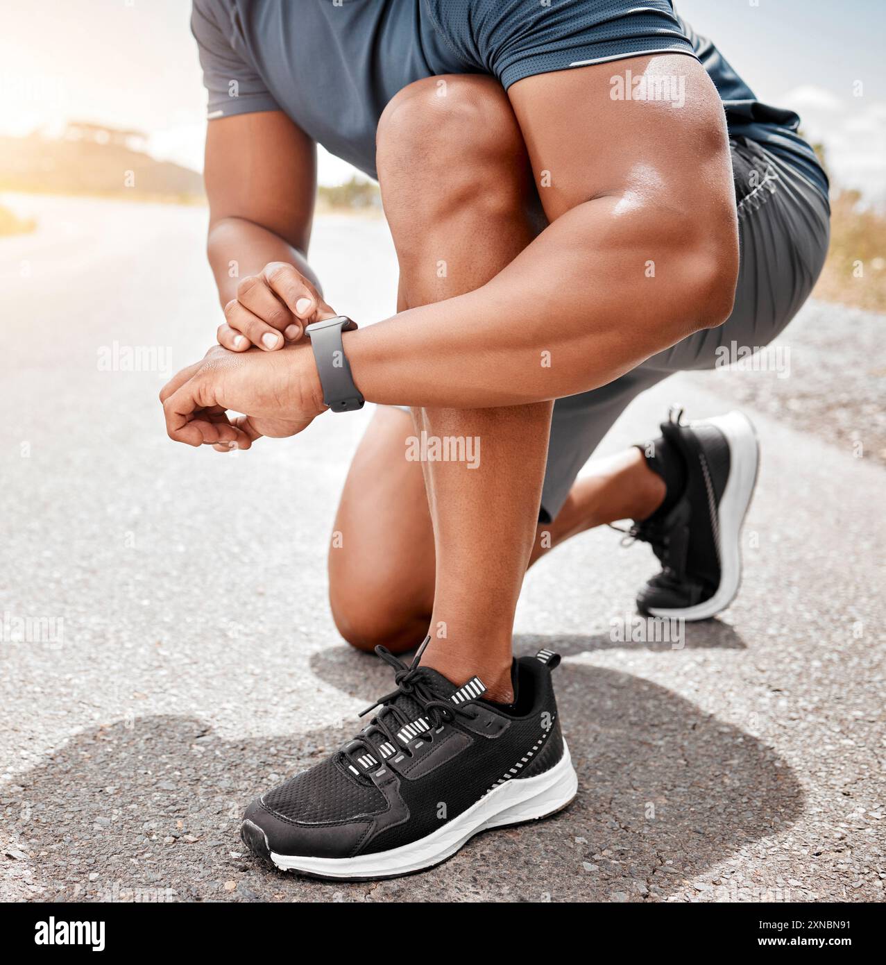 Man, hands and check smart watch outdoor on road for running time ...