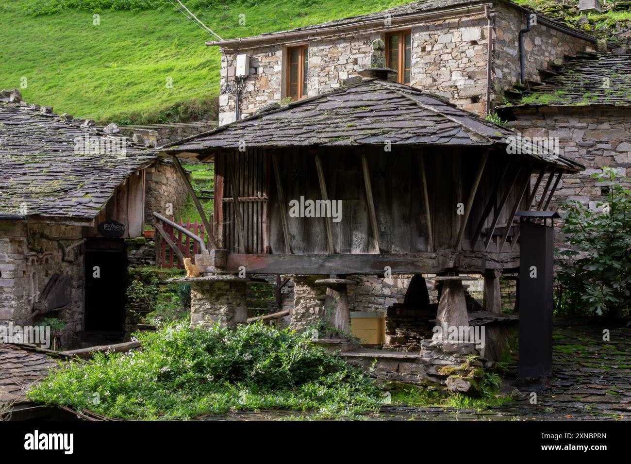 Rustic stone cottage exterior with porch and village setting. Asturias ...