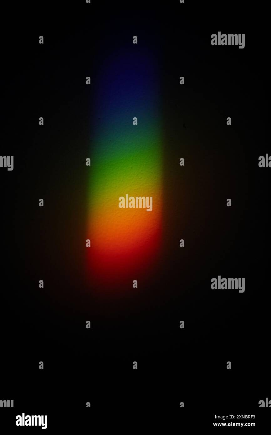 Prism rainbow Colours refracted onto ceiling in photographers home. red ...