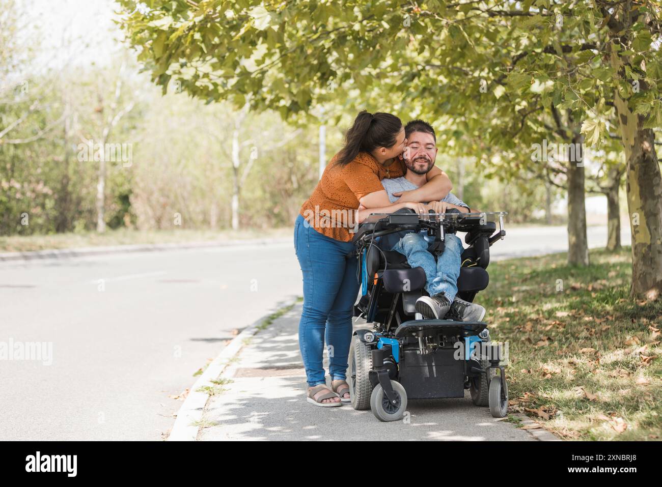 Moment of tenderness, a woman kissing and hugging her husband with a ...