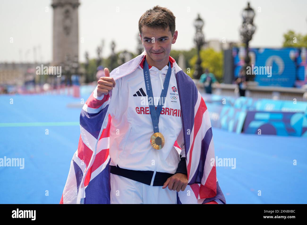 Gold medalist Britain's Alex Yee poses with his medal at the end of a ...