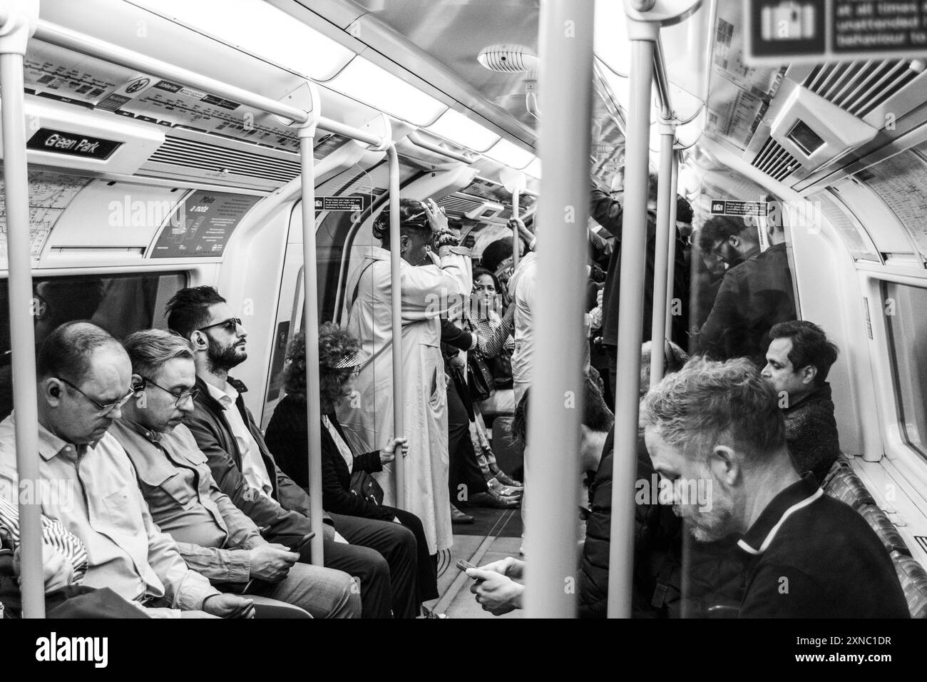 People travelling on a crowded London Underground train carriage ...