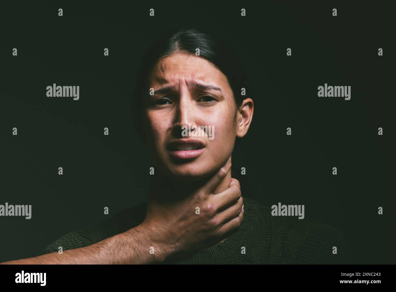 Woman, abuse and strangle with hand in studio with scared, anxiety or ...