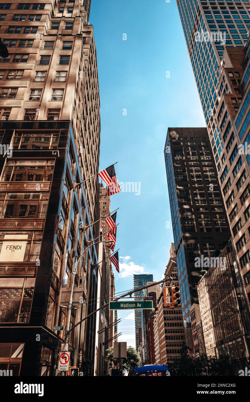 Tall modern buildings with American flags in downtown New York ...