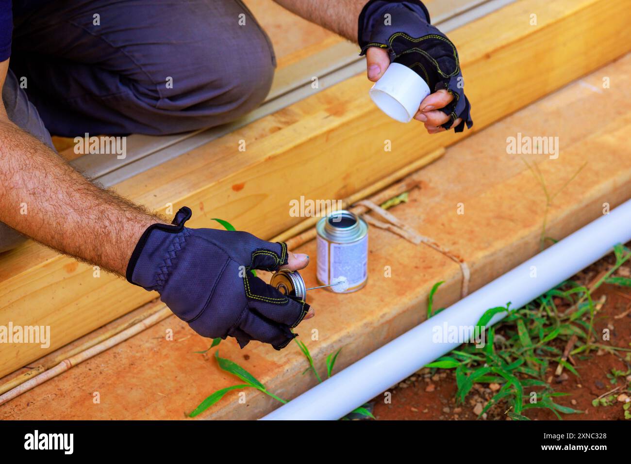 Plumber glued plastic PVC water system during laying of water supply ...
