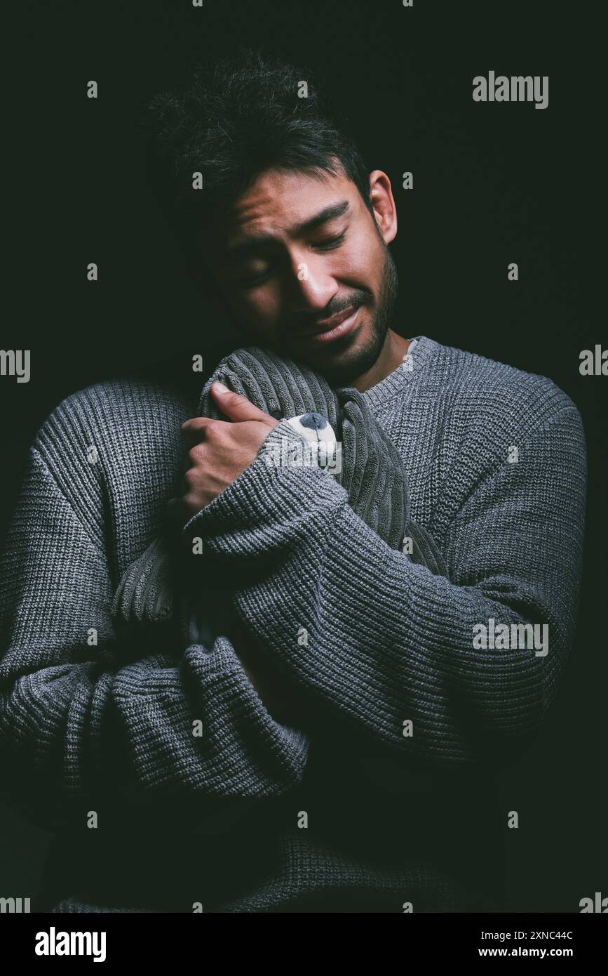 Studio, mental health and man with cuddle of teddy bear for trauma ...