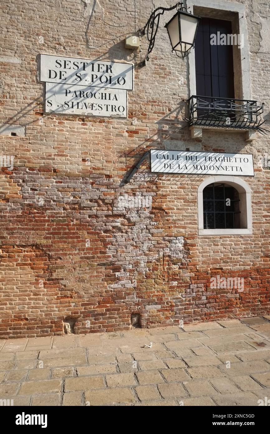 Venice, Italy, wall signs on a weathered venetian brick wall with an ...