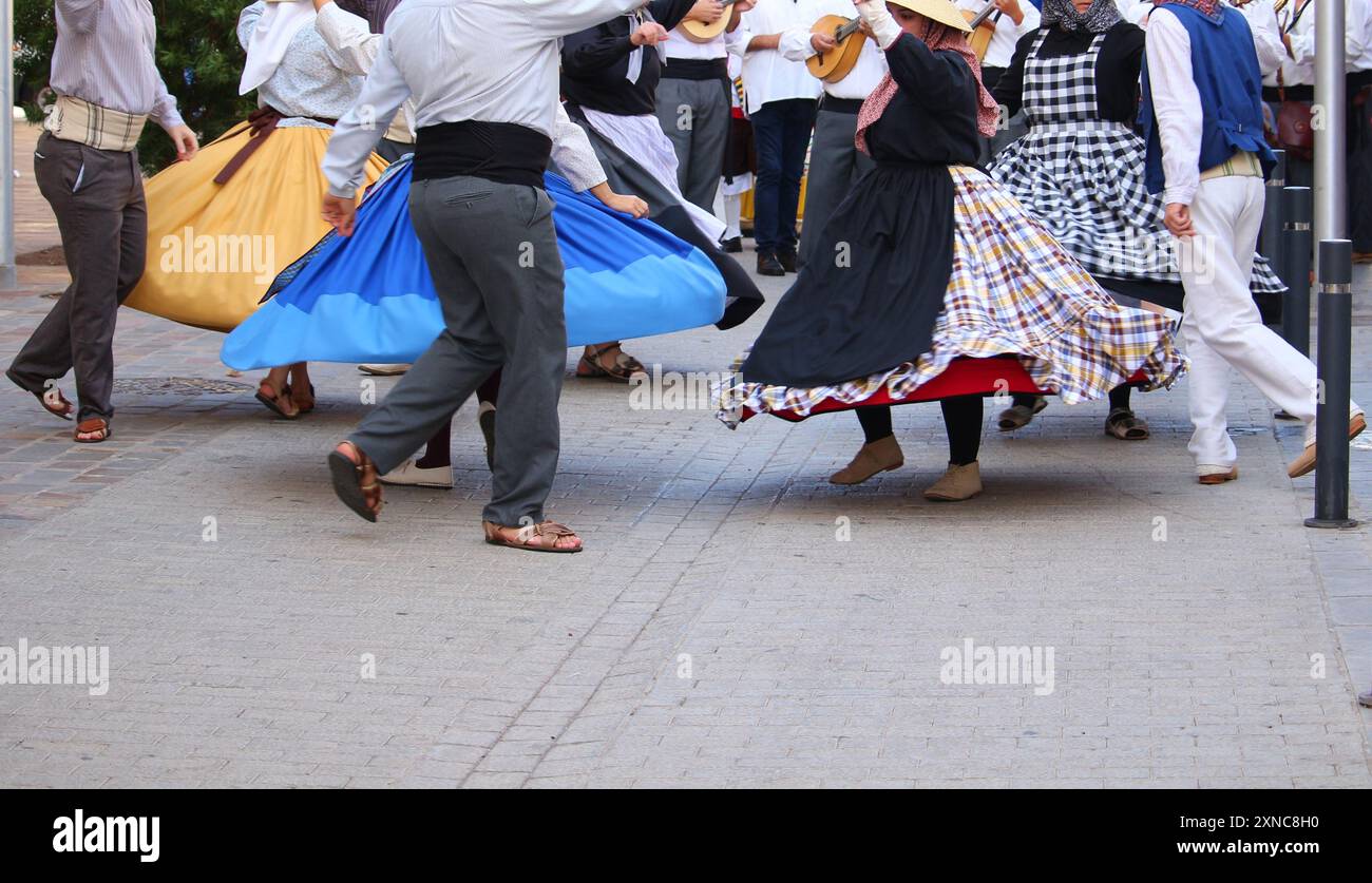 Local dancers in traditional dresses at a public Canarian festival with ...