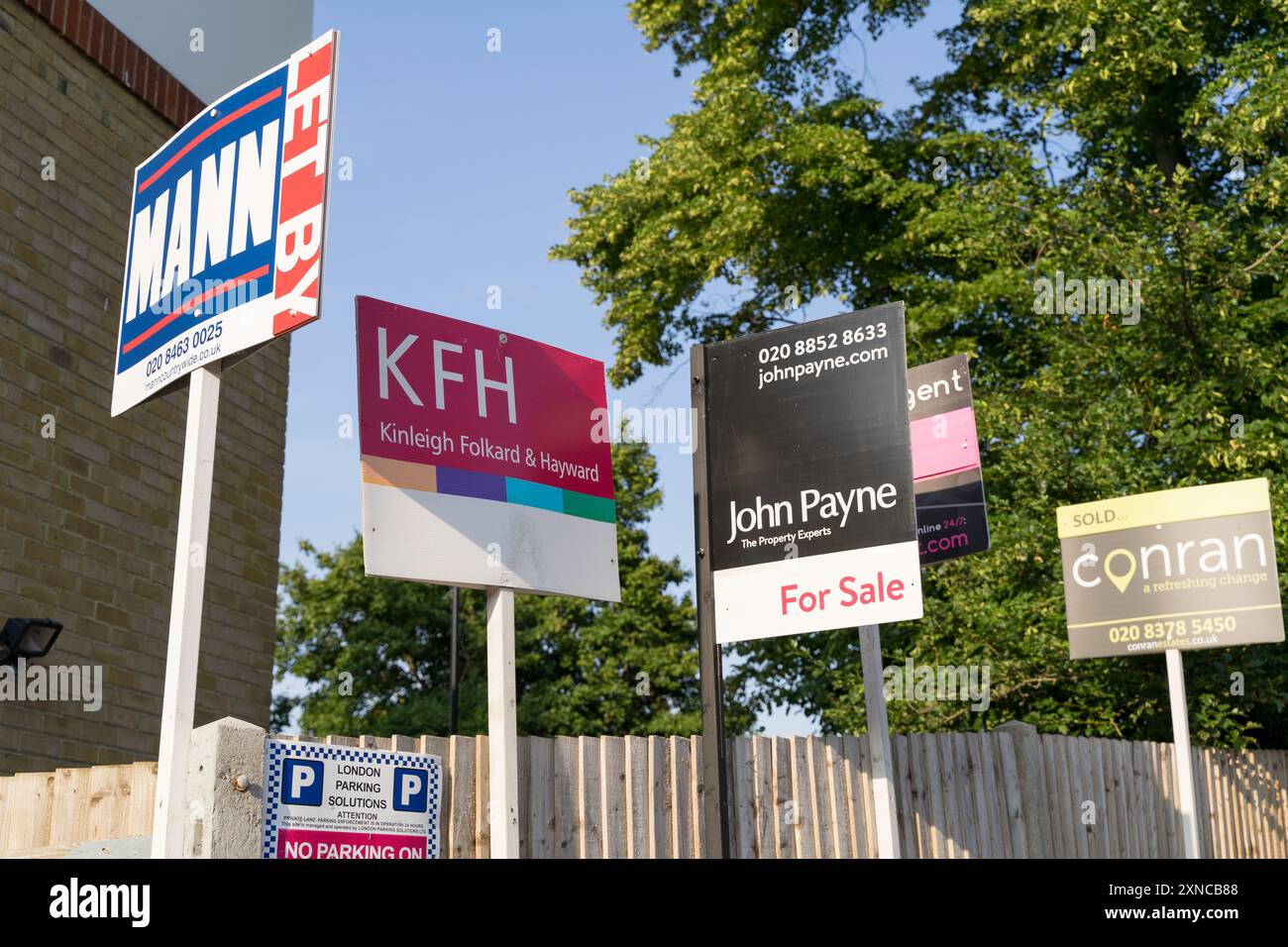 Multiple "for sale" signage from different estate agents erected on ...