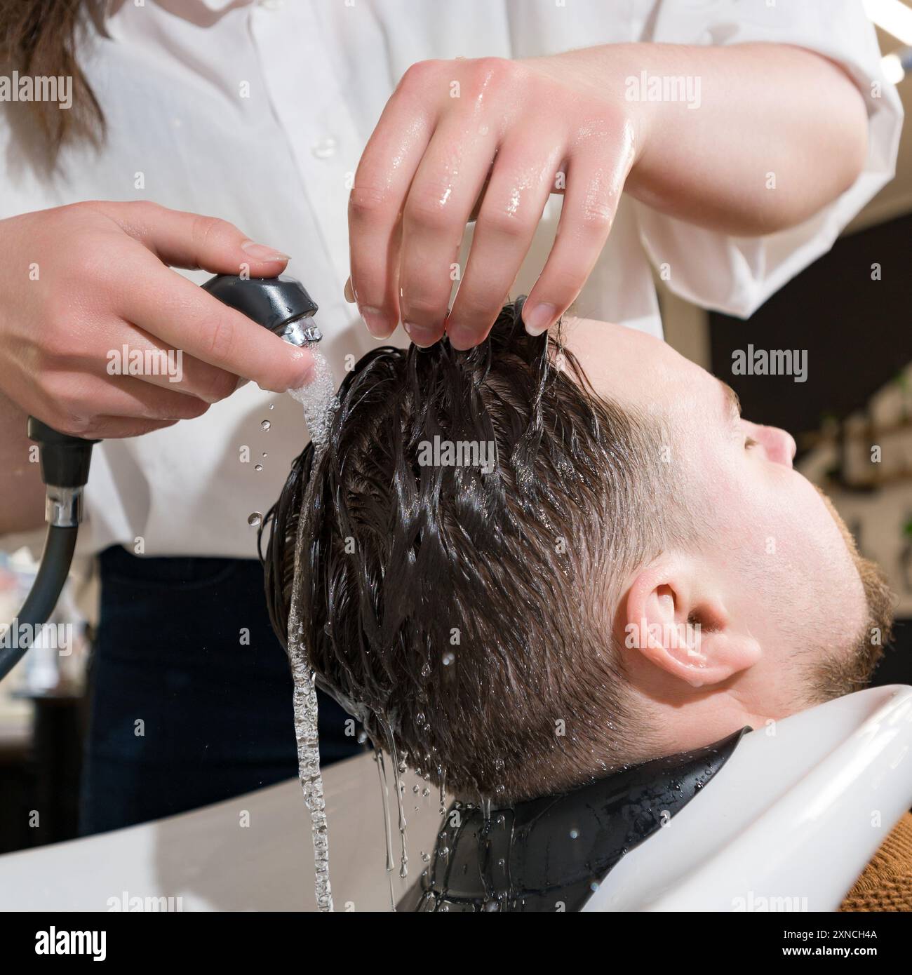 Barber shampooing washing a male clients head in the sink Stock Photo ...