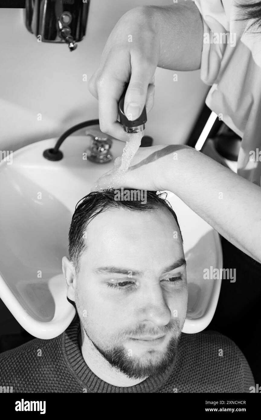 Washing male hair in barber Black and White Stock Photos & Images - Alamy