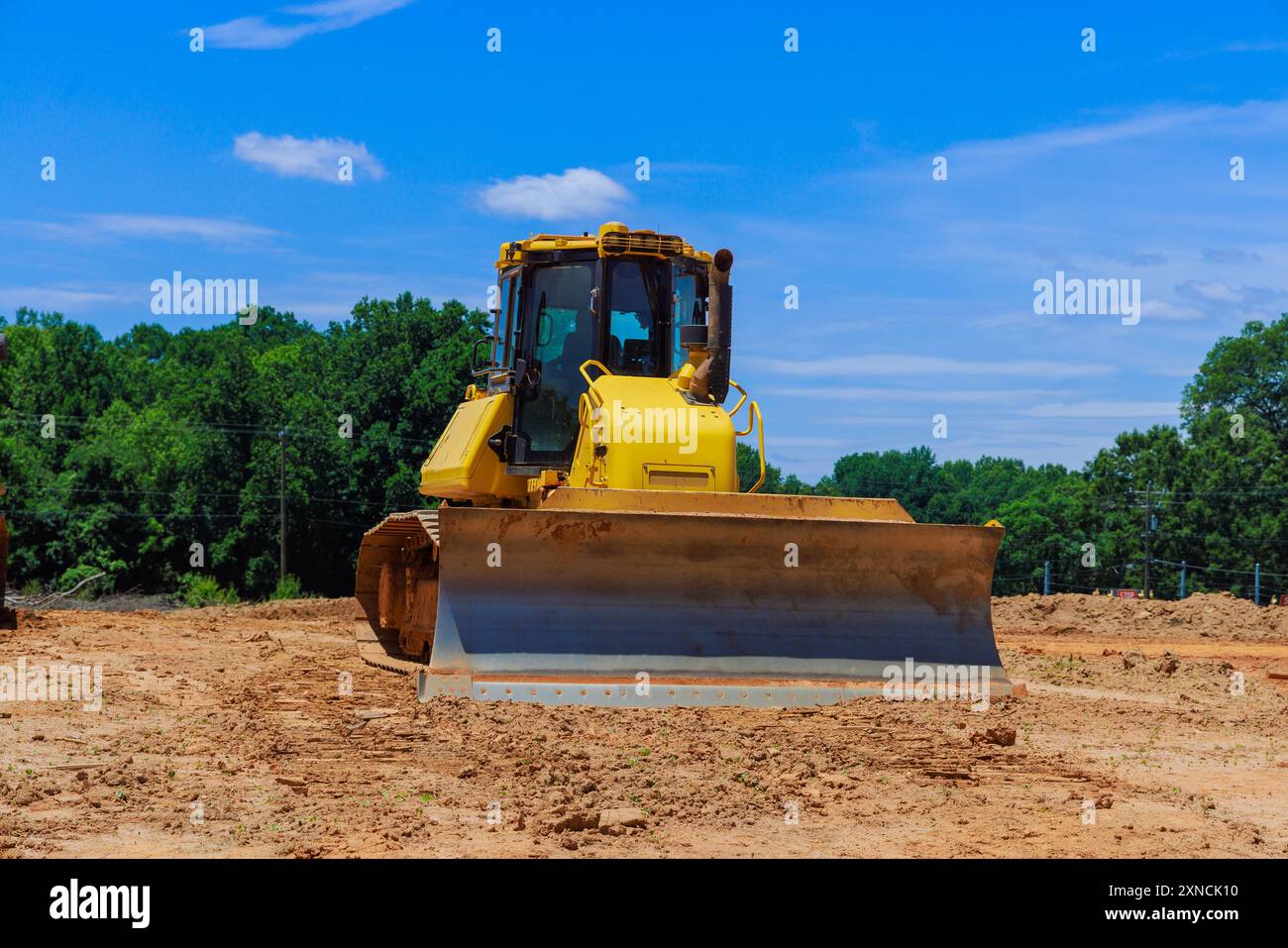 Earthworks on construction site with powerful wheel loader bulldozer ...