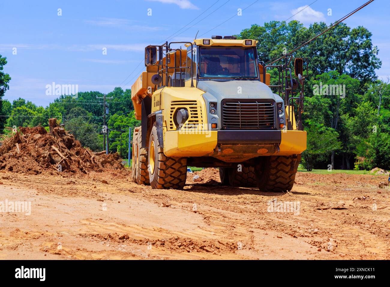 Powerful wheel dumper working on construction site Stock Photo - Alamy